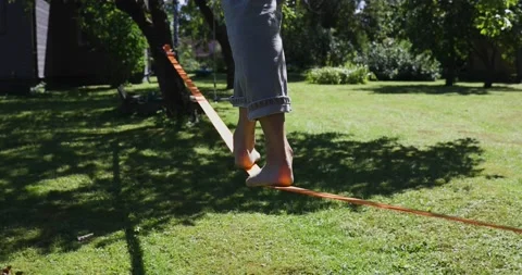 A person walking on slackline training b... | Stock Video | Pond5