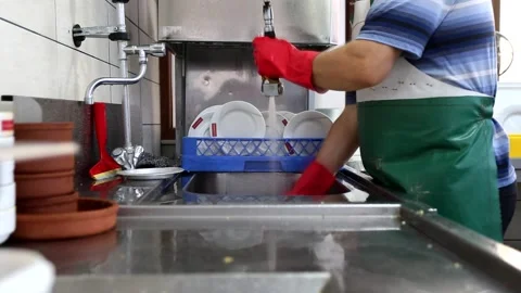 A person washing dishes in a restaurant | Stock Video | Pond5