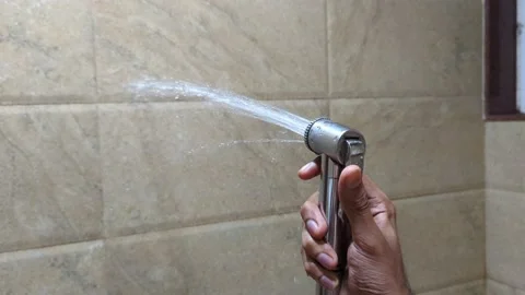 a person wasting water by spraying water... | Stock Video | Pond5