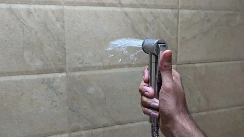 a person wasting water by spraying water... | Stock Video | Pond5