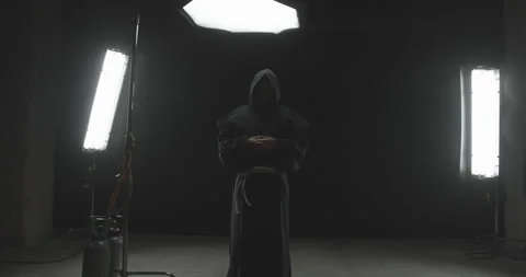 A Person Wearing a Black Robe on a Black... | Stock Video | Pond5