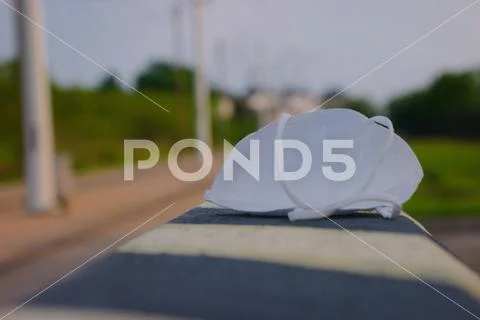 Photograph: Personal Protective Equipment Mask on concrete wall #128019132