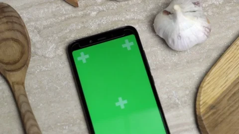 Phone on kitchen platform with green scr... | Stock Video | Pond5