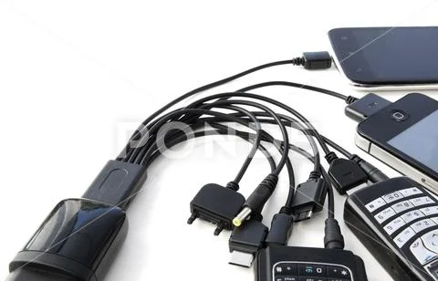 Phones are connected to different types of charger connectors, Stock ...