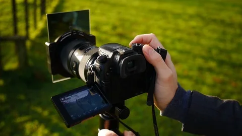 Photographer adjusting camera focus aper... | Stock Video | Pond5