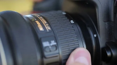 Photographer adjusting focus on camera l... | Stock Video | Pond5