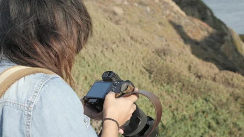 Photographer Looks At Back Of Camera | Stock Video | Pond5