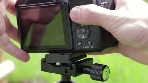 Photographer mounts a digital camera on ... | Stock Video | Pond5