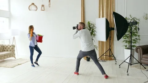 Photographer works in studio with model... | Stock Video | Pond5