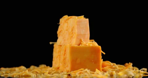 Pieces grated cheddar cheese falling tab... | Stock Video | Pond5