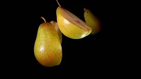 Pieces of pear rotate on a black backgro... | Stock Video | Pond5