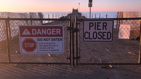 Pier closed signs of danger where a beac... | Stock Video | Pond5