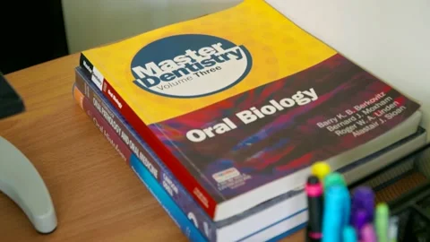 A pile of books of dental and oral in la... | Stock Video | Pond5