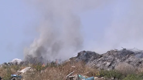 A pile of garbage burning and smoking cr... | Stock Video | Pond5