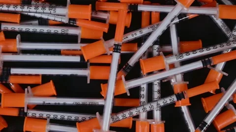 Pile of insulin needles with orange caps | Stock Video | Pond5
