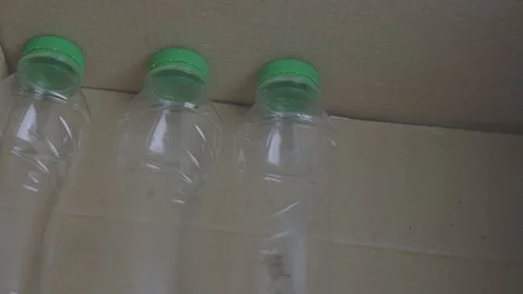 Pile of plastic bottles falling on cardb... | Stock Video | Pond5