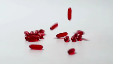 Pile of red pills falling down on white ... | Stock Video | Pond5