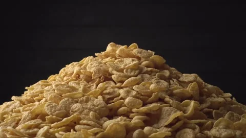 A pile of yellow corn flakes slowly rota... | Stock Video | Pond5