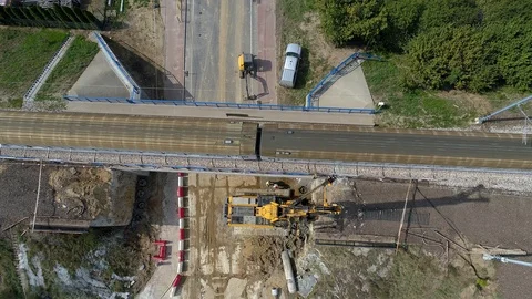 Piling close-up, passing train in the ba... | Stock Video | Pond5