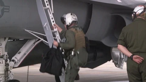 Pilot climbing cockpit ladder to F/A-18 ... | Stock Video | Pond5