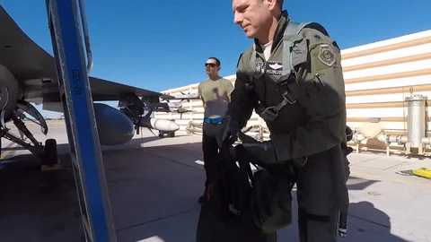 Pilot climbing steps into cockpit of F-1... | Stock Video | Pond5