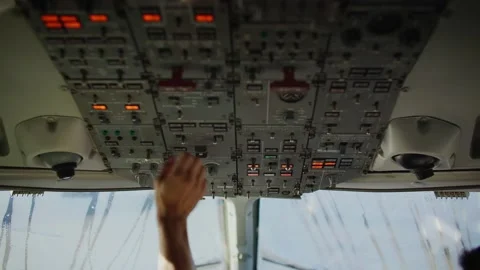 Pilot turning dials in cockpit, control ... | Stock Video | Pond5