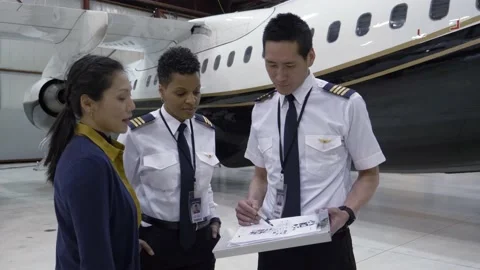 Pilots and flight attendant talking in a... | Stock Video | Pond5