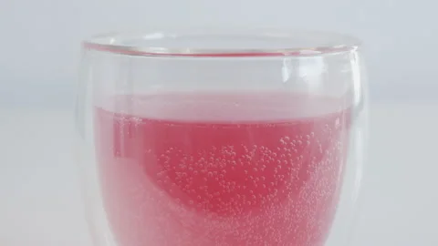 Pink effervescent tablet dissolved in gl... | Stock Video | Pond5