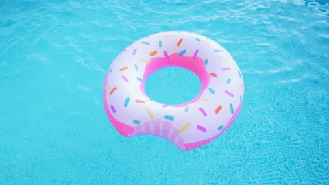 Pink inflatable donut ring floating in c... | Stock Video | Pond5