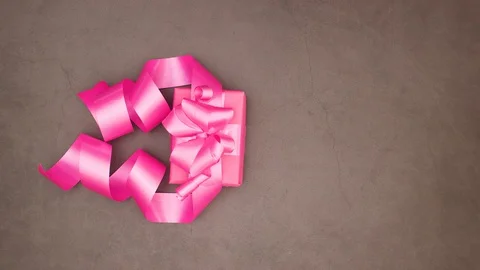 Pink present with big pink ribbon runs o... | Stock Video | Pond5