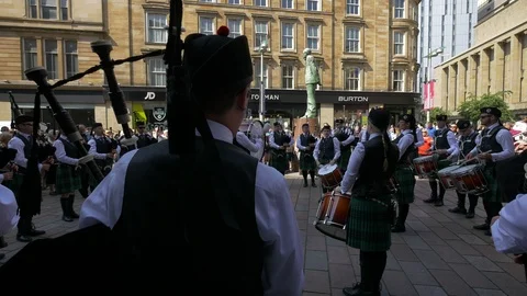 A pipe band in uniforms playing on the s... | Stock Video | Pond5