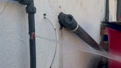 pipe burst shooting water from a whole i... | Stock Video | Pond5