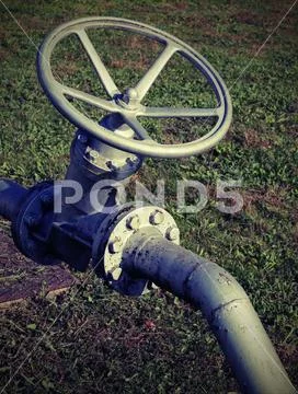 Pipe closure valve of the industrial plant and old toned effect Stock ...