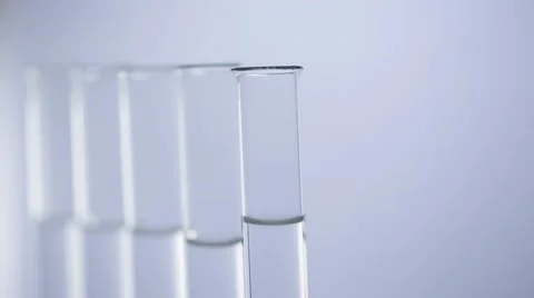 A pipette drips transparent water into a... | Stock Video | Pond5