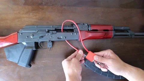 placing a cable lock on a featureless AK... | Stock Video | Pond5