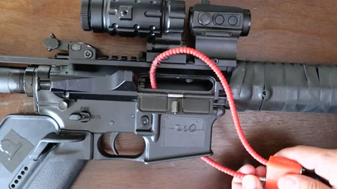 Placing a cable lock on a featureless AR... | Stock Video | Pond5