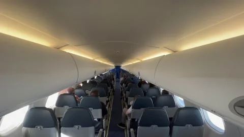 Plane cabin seen from the back. Passenge... | Stock Video | Pond5