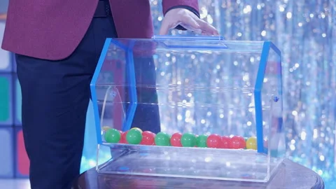 Plastic balls are mixed in a bingo drum.... | Stock Video | Pond5