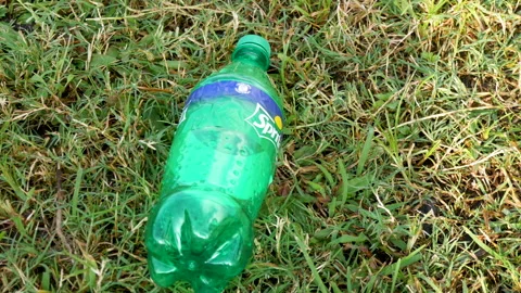 Plastic bottle of sprite in a ground wit... | Stock Video | Pond5