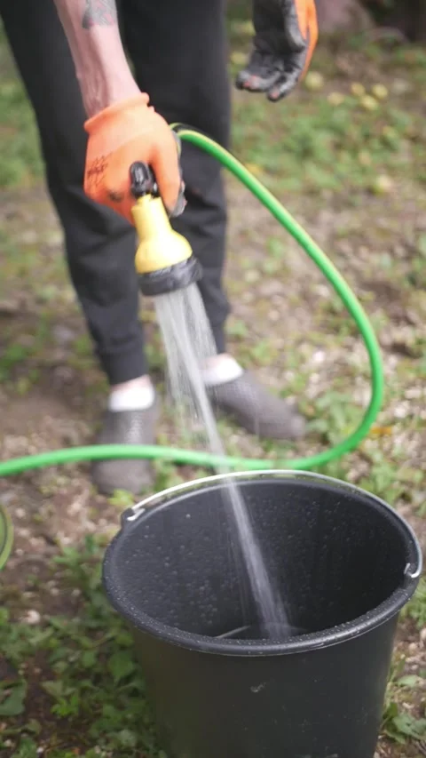 A plastic bucket is filled with water fr... | Stock Video | Pond5
