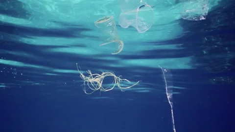 Plastic debris floating below surface in... | Stock Video | Pond5