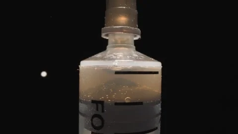 Plastic syringe with old liquid turning ... | Stock Video | Pond5