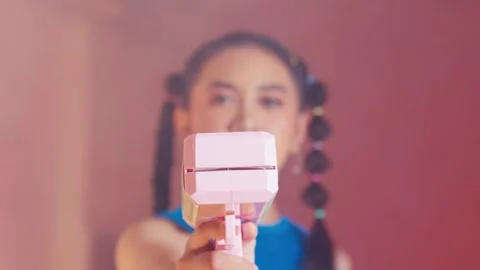 Playful Girl Aiming a Pink Toy Gun | Stock Video | Pond5