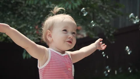 Playful Little Girl Popping Bubbles Outd... | Stock Video | Pond5