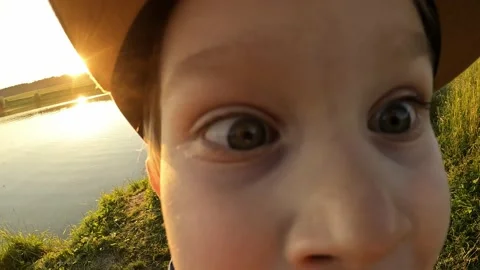 Playful male kid in cap fooling smiling ... | Stock Video | Pond5