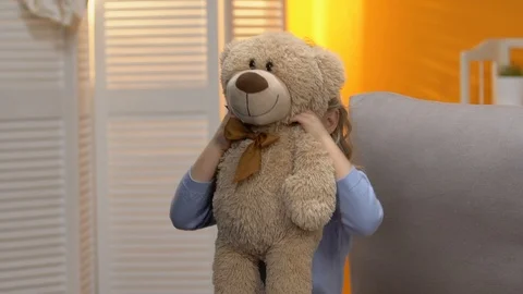 Playful sweet little girl hiding behind ... | Stock Video | Pond5