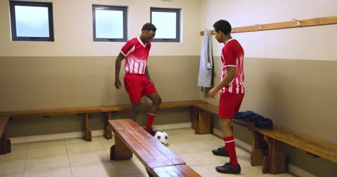Playing soccer in locker room, two male ... | Stock Video | Pond5