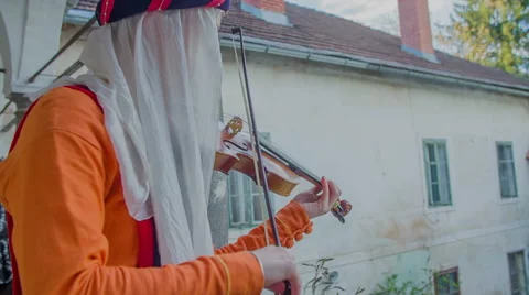 Playing a violin on the balcony | Stock Video | Pond5