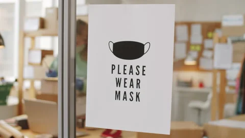 Please Wear Mask Poster on Glass Wall in... | Stock Video | Pond5