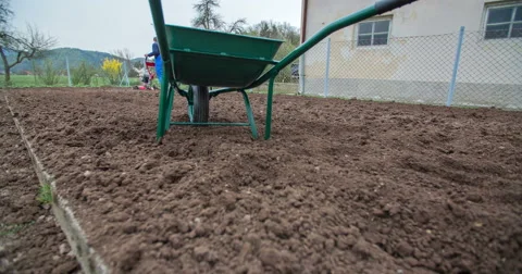 Plowing the manure soil in the garden's ... | Stock Video | Pond5